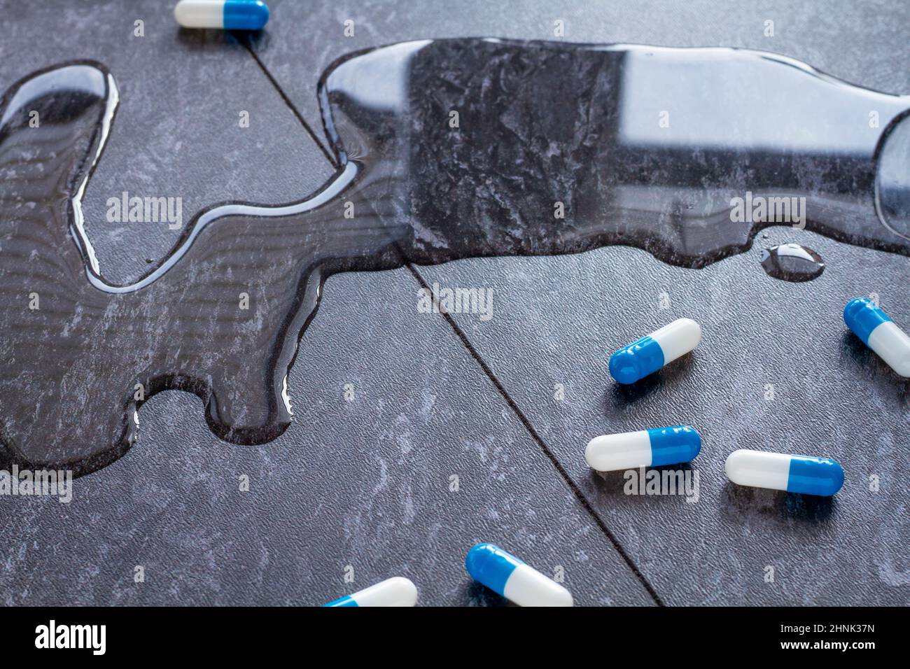 Tablets. Water is spilled and medical capsules are scattered. Ambulance ...