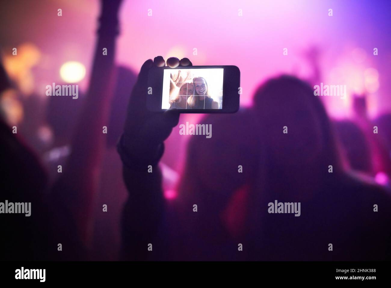 Shot of a fan filming a concert on their camera. This concert was ...