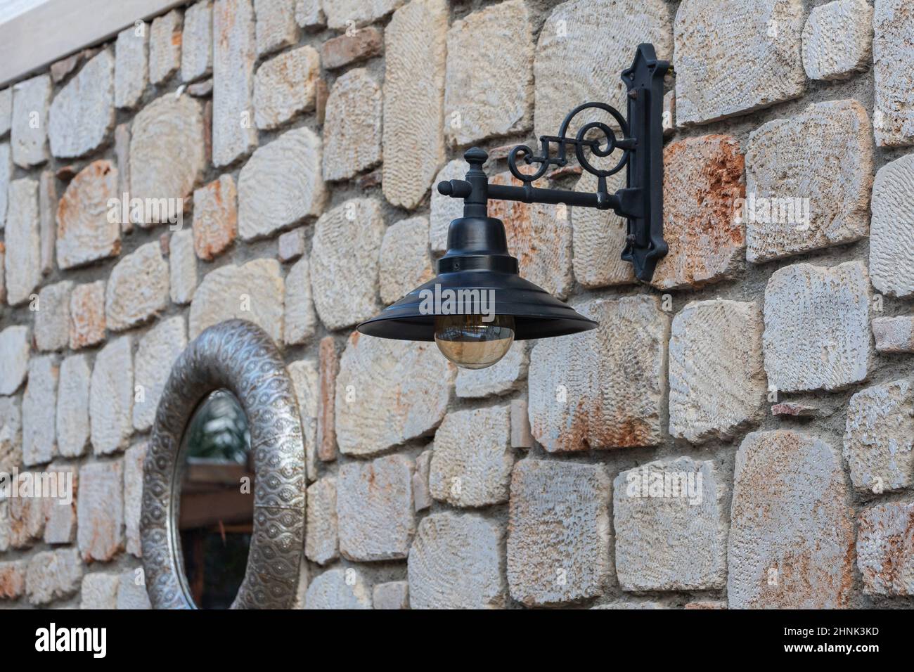 Beautiful street lamps on a stone wall. Background texture of the stone ...