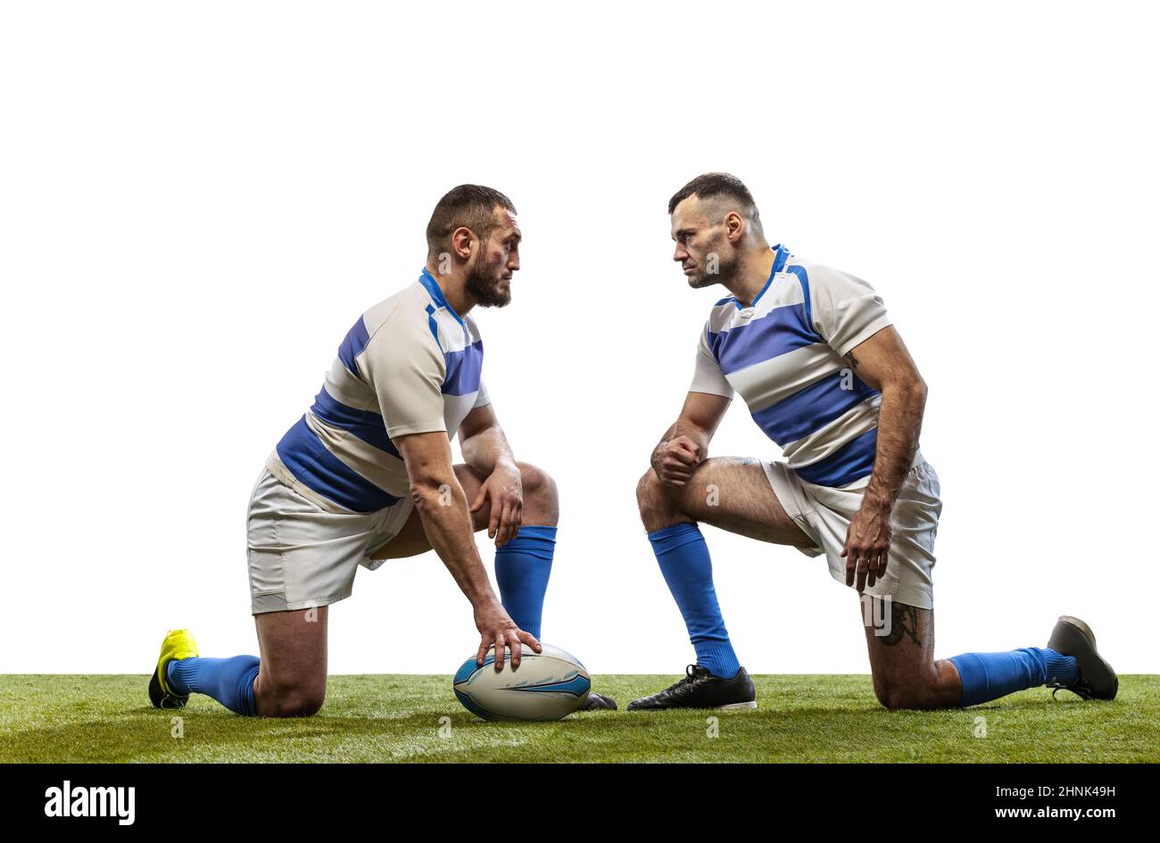 Dynamic portrait of male rugby players playing rugby football on grass ...