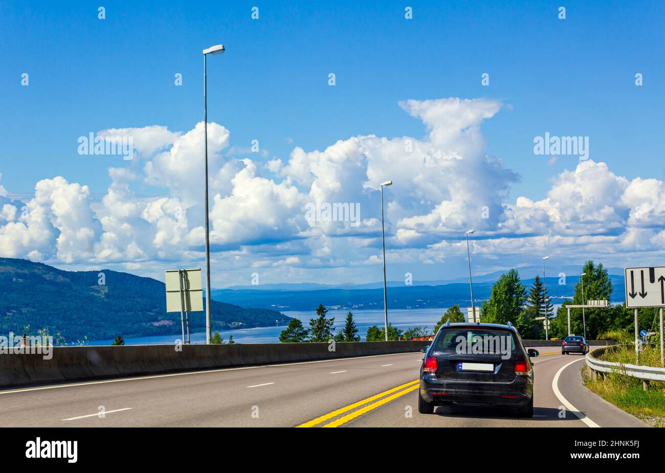 Driving through Norway in summer with a view of the mountains and the ...