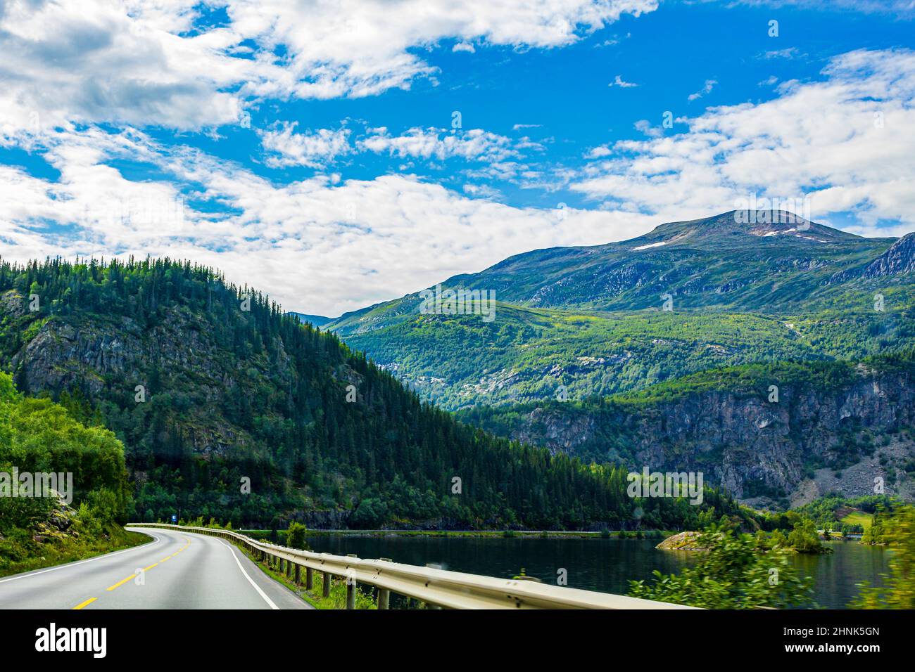Driving through Norway in summer with a view of the mountains and the ...