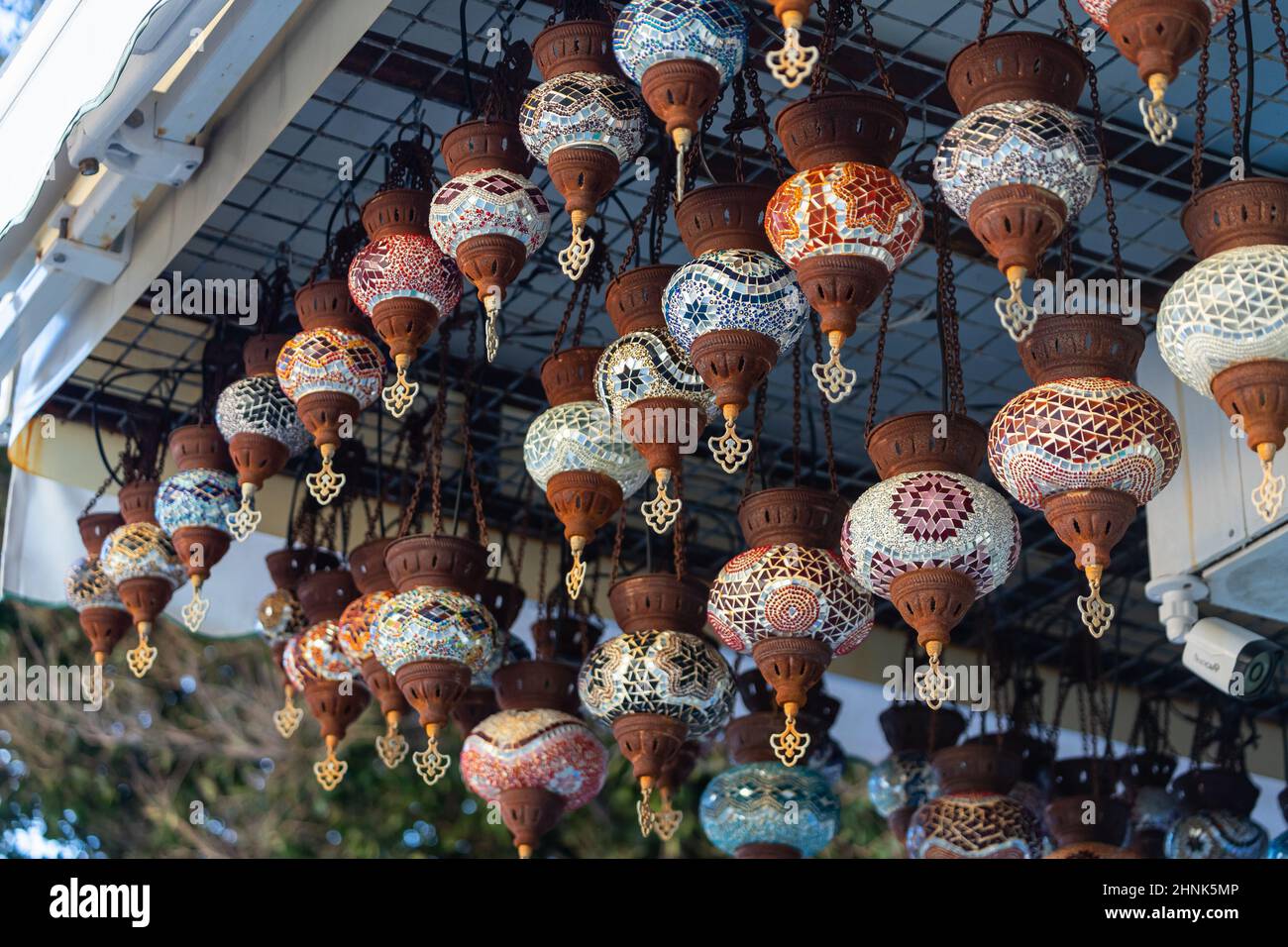bright glass lamps in the market stall from the ceiling in a gift shop ...