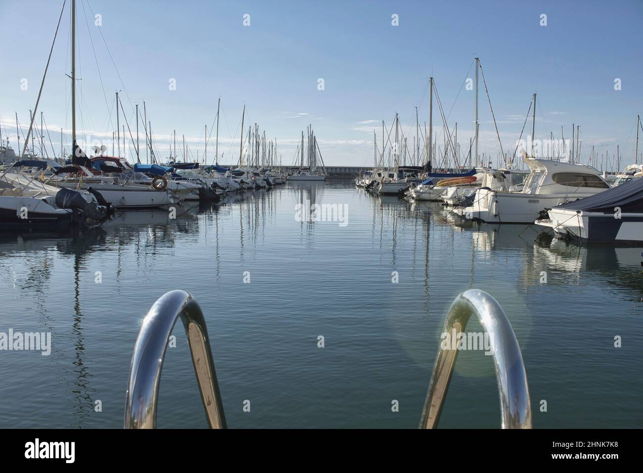 boats and yachts moored at pier on a sunny day Stock Photo - Alamy