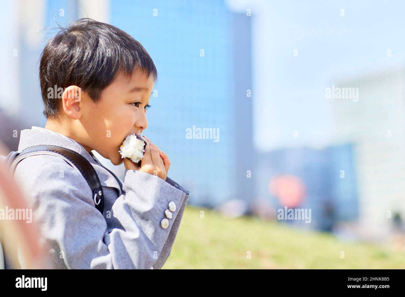 Japanese Elementary School Student Eating A Rice Ball Stock Photo - Alamy