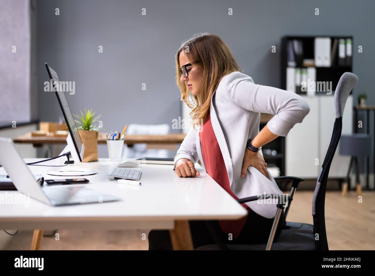 Back Pain Bad Posture Woman Sitting In Office Stock Photo - Alamy