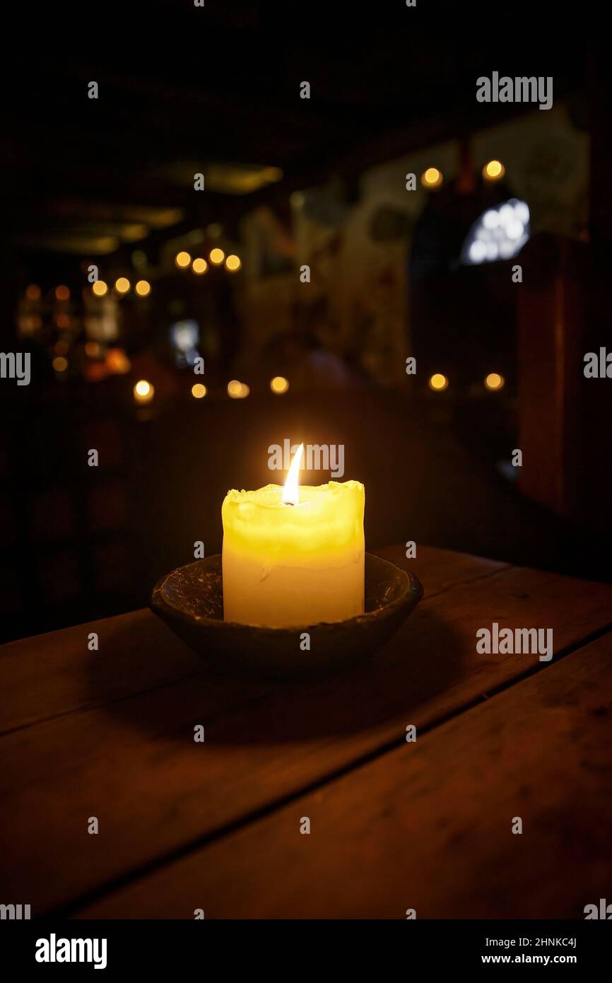 Candle on a table in a medieval tavern Stock Photo - Alamy