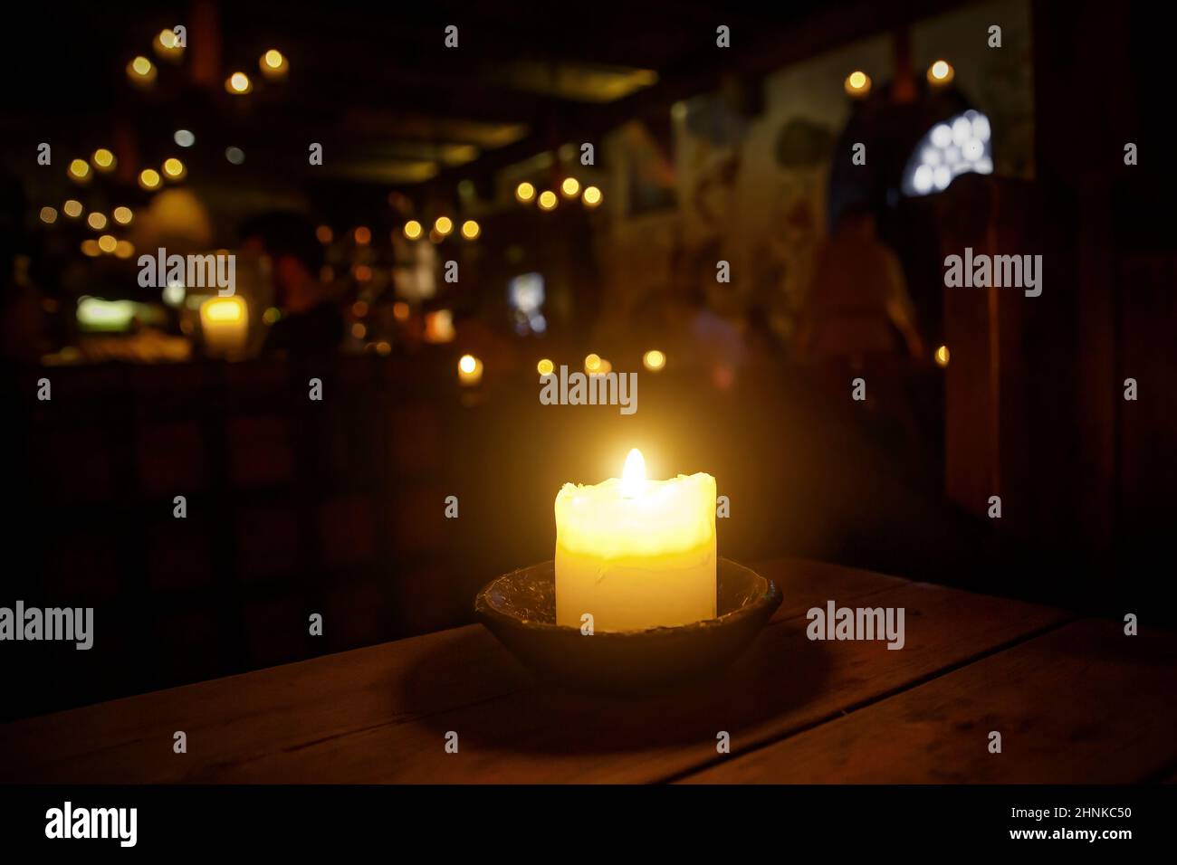 Candle on a table in a medieval tavern Stock Photo - Alamy