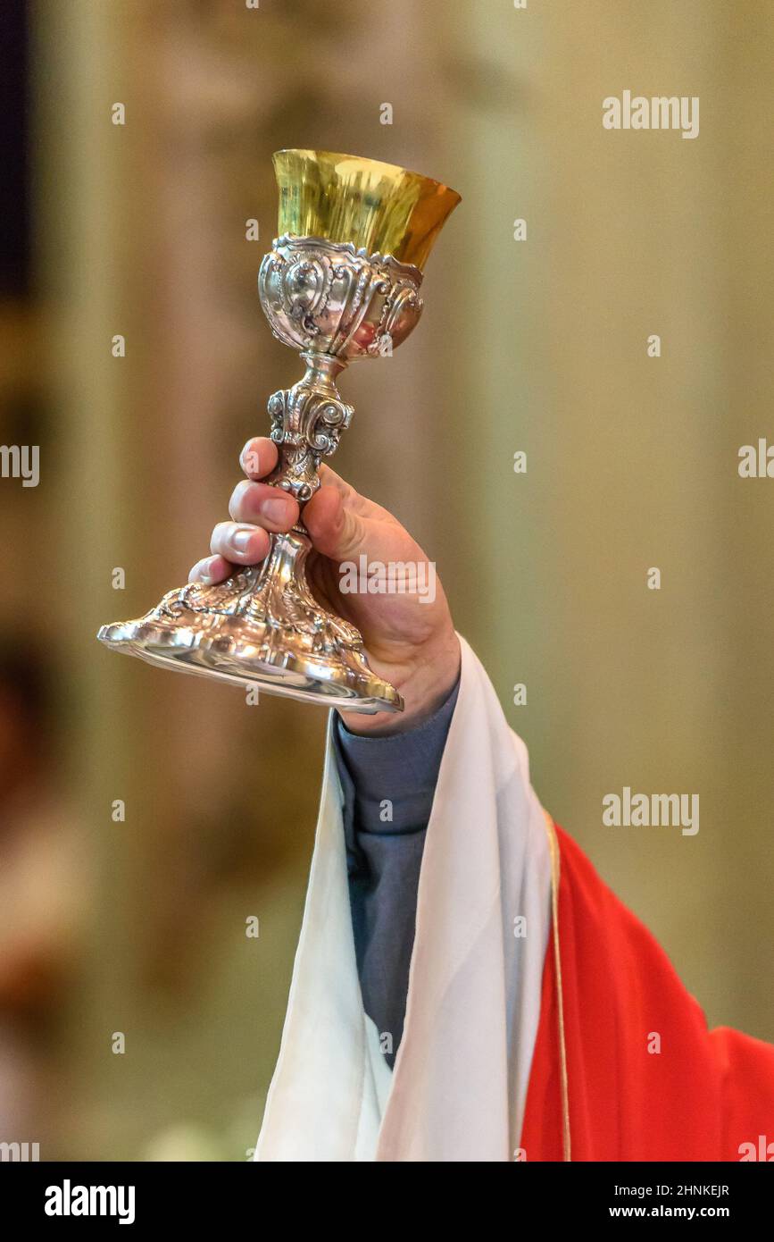 Priest giving Eucharist Stock Photo - Alamy