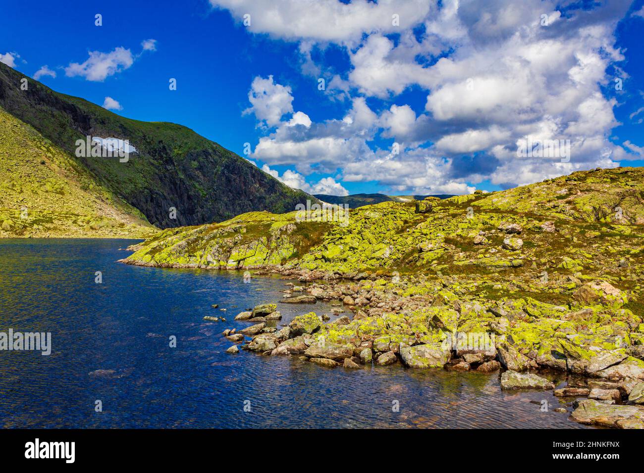 Amazing norwegian landscape with Boulders and lake at the summit on the ...