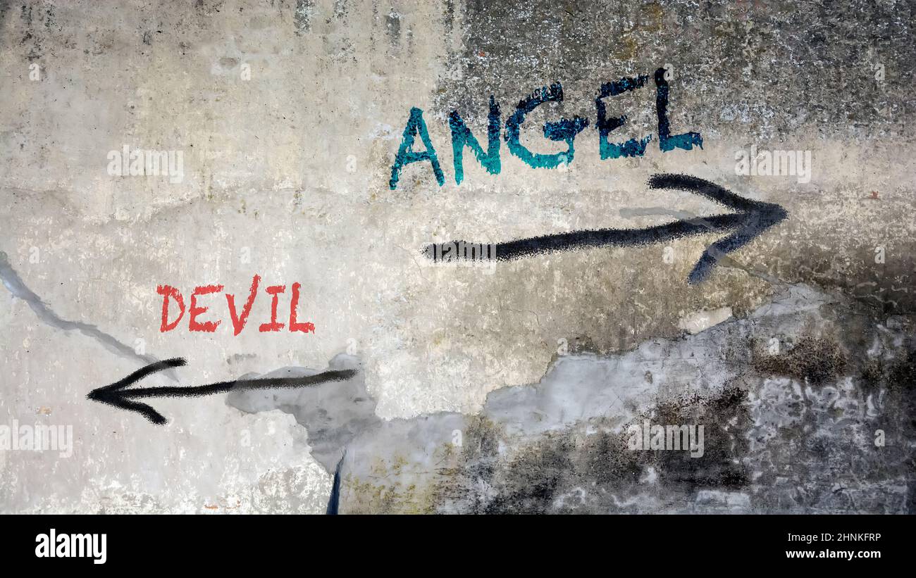 Street Sign the Direction Way to Angel versus Devil Stock Photo - Alamy