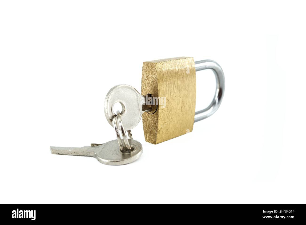 Brass lock with with keys in the hole isolated on the white background ...