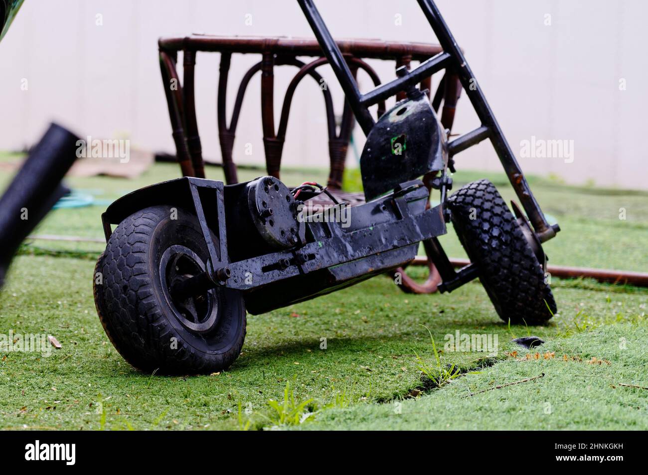 Black electric scooter on the grass close-up Stock Photo - Alamy