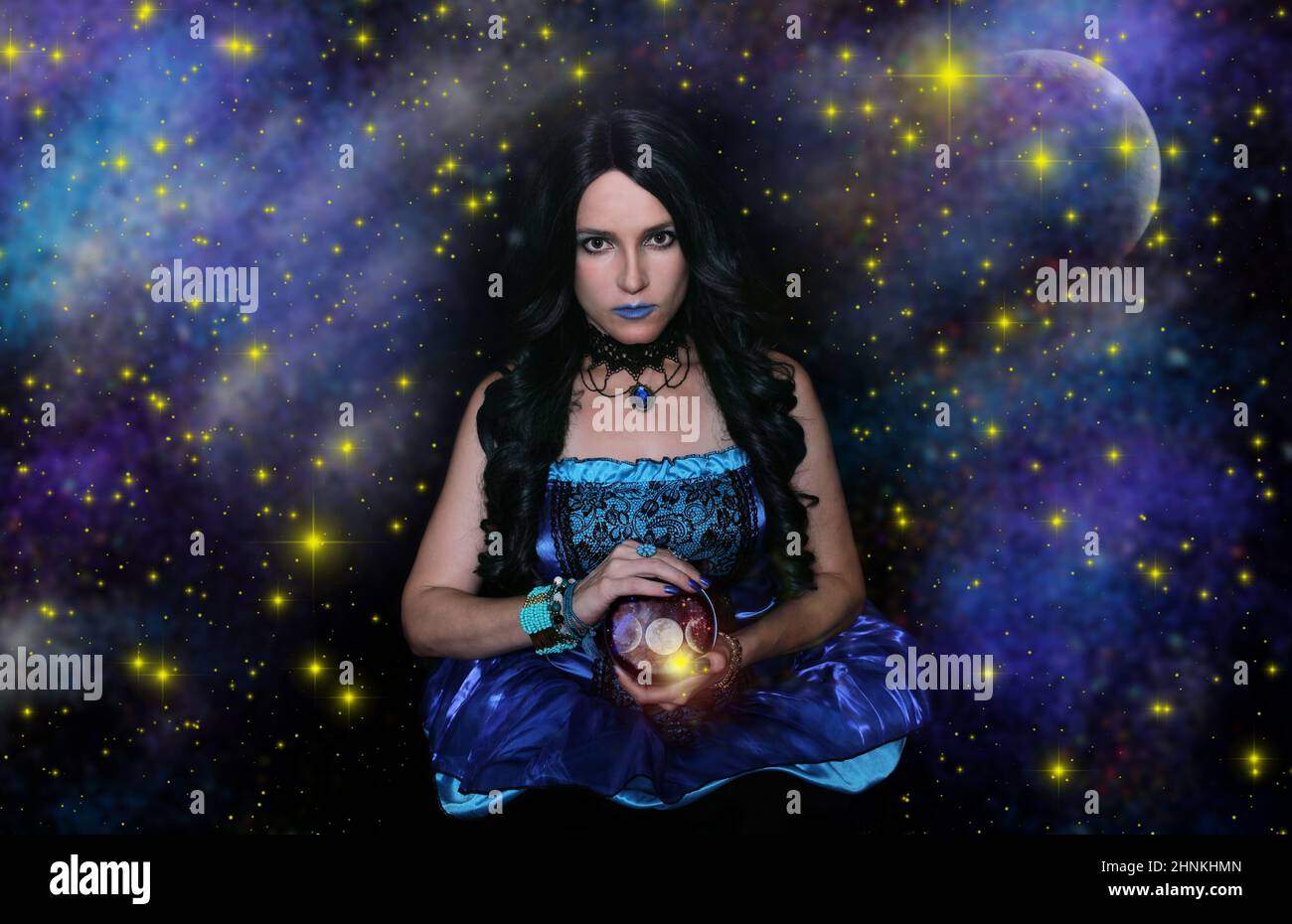Female Psychic with Crystal Ball and galaxy background Stock Photo - Alamy