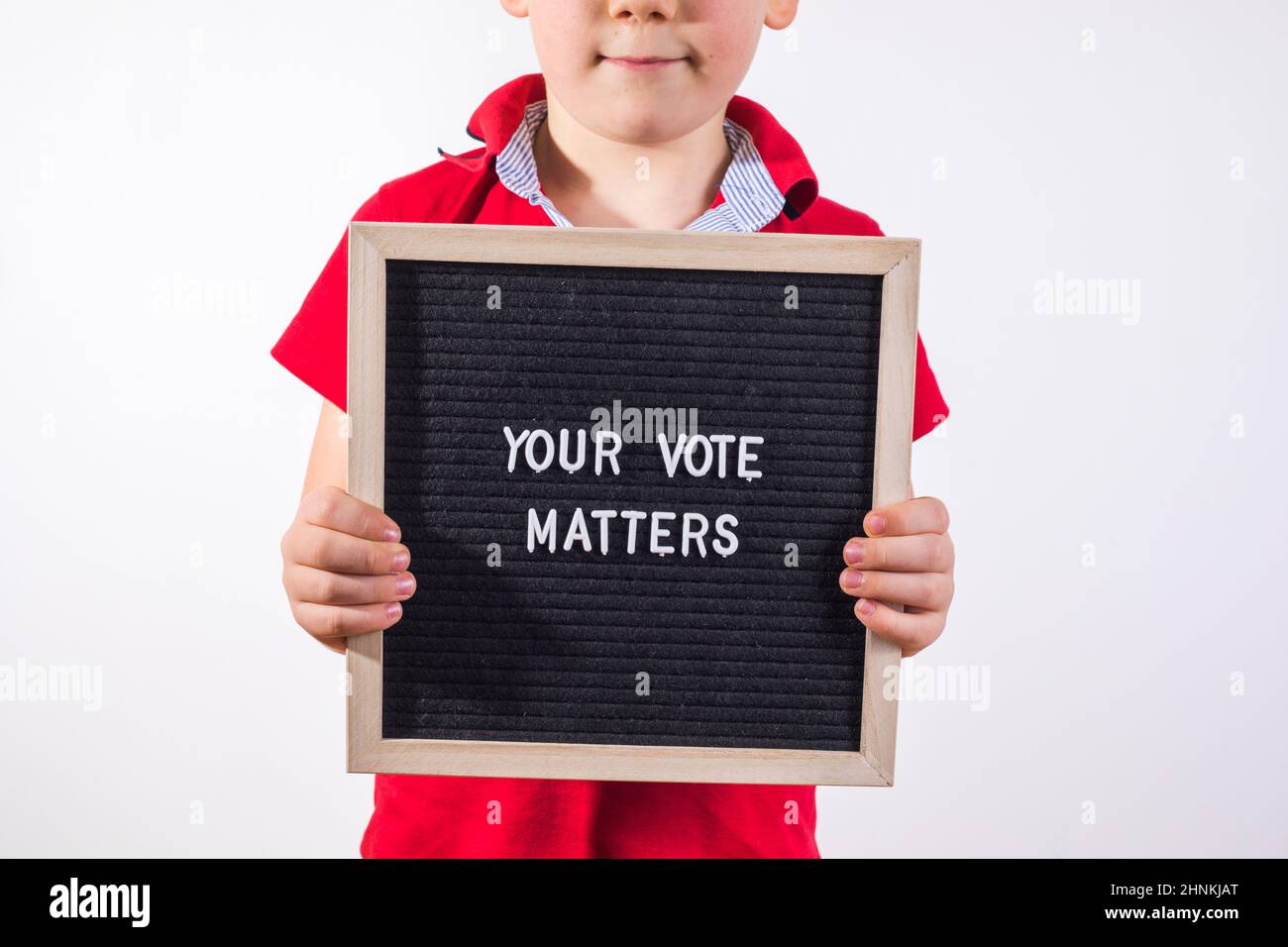 kid boy holding letter board with text Your Vote Matters on white ...