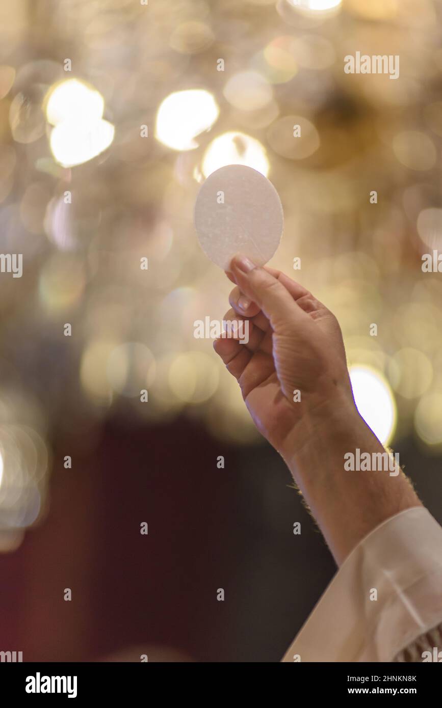 The sacred gesture during the christian mass: showing the holy bread ...