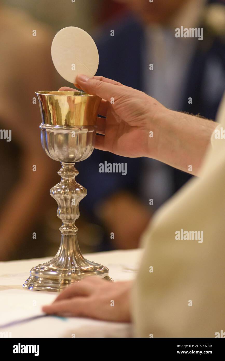 The sacred gesture during the christian mass: showing the holy bread ...