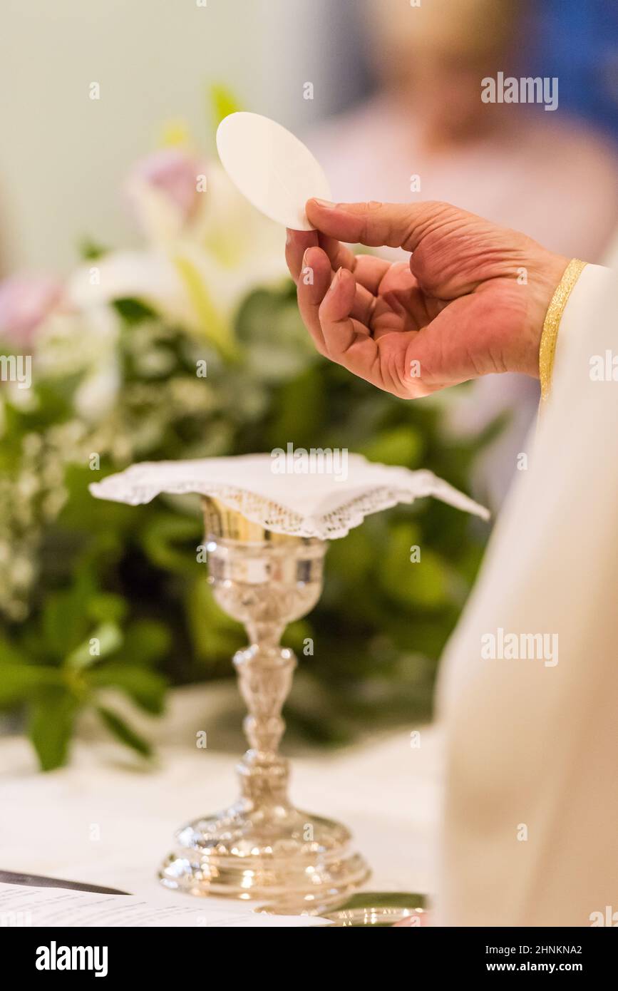During the christian mass a priest celebrates the rite of the communion ...