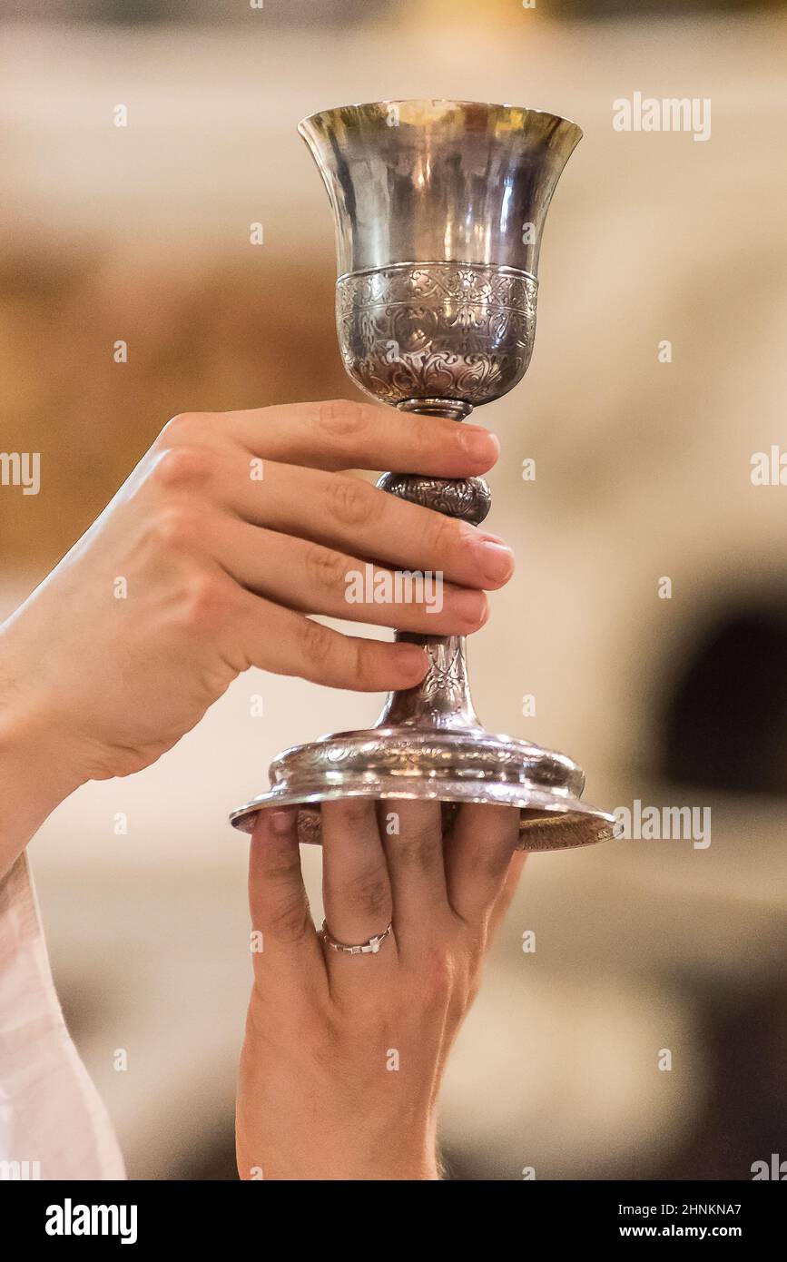 During the christian mass a priest celebrates the rite of the communion ...