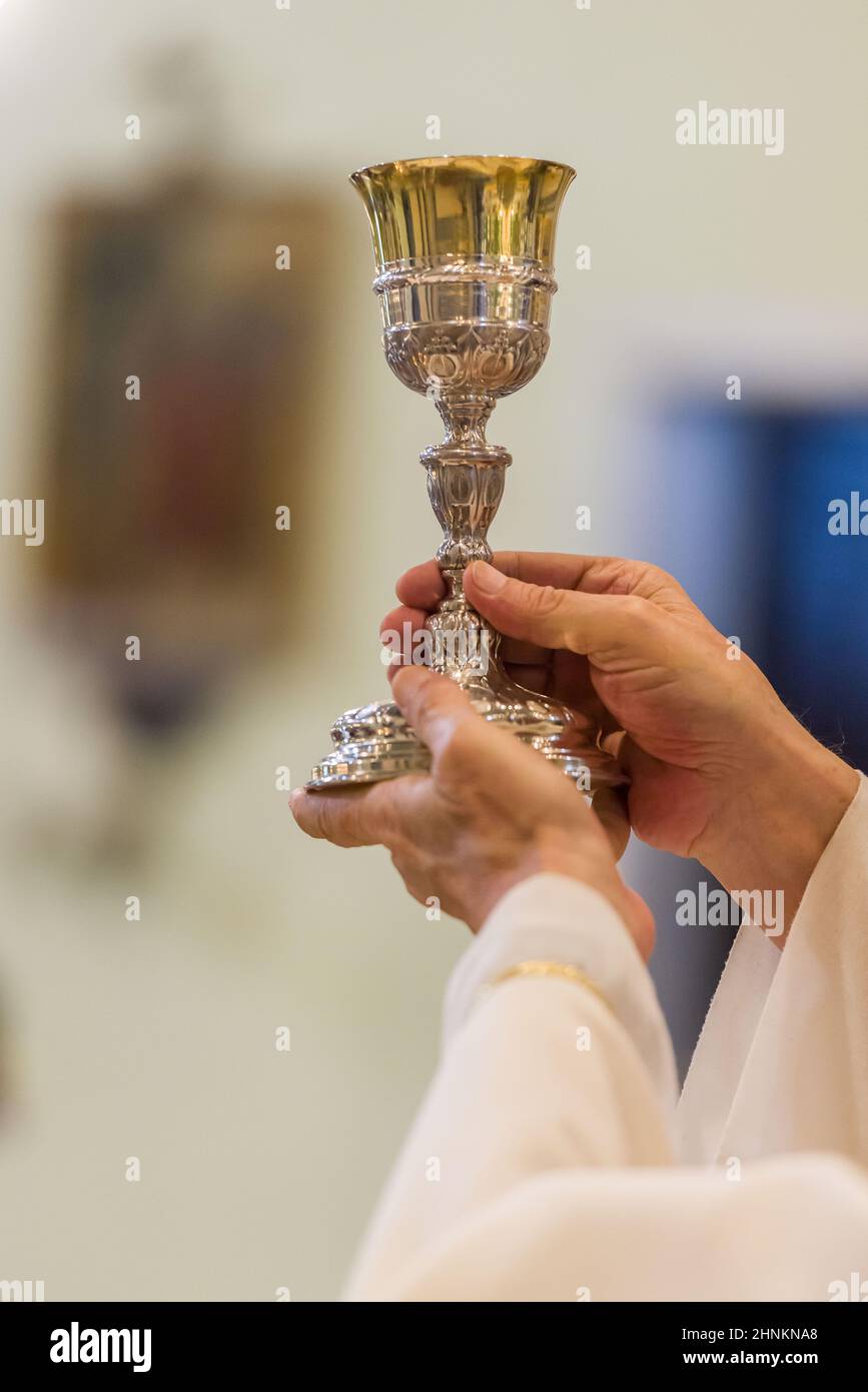 During the christian mass a priest celebrates the rite of the communion ...