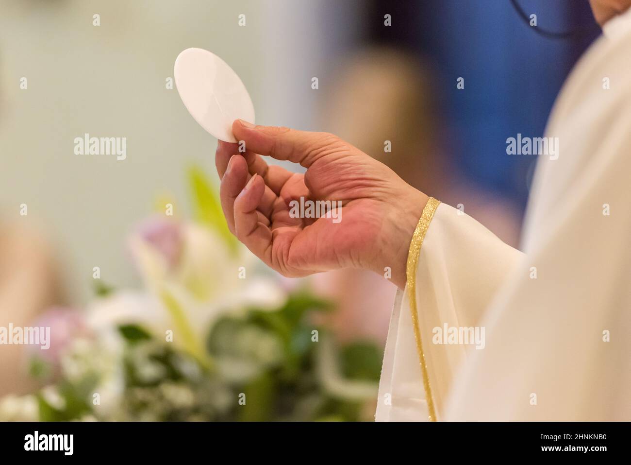 During the christian mass a priest celebrates the rite of the communion ...