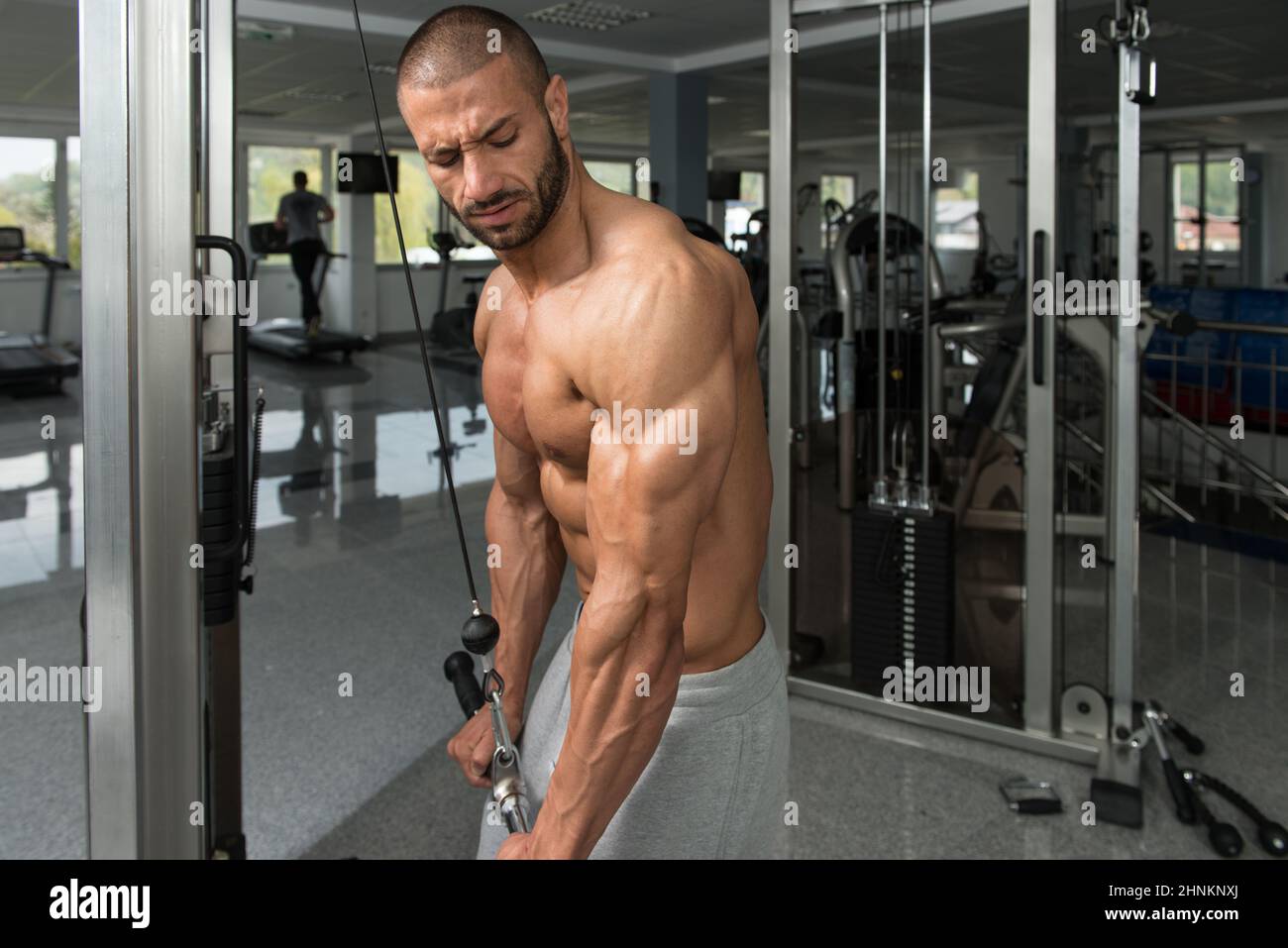 Bodybuilder Doing Heavy Exercise For Triceps With Cable Stock Photo - Alamy