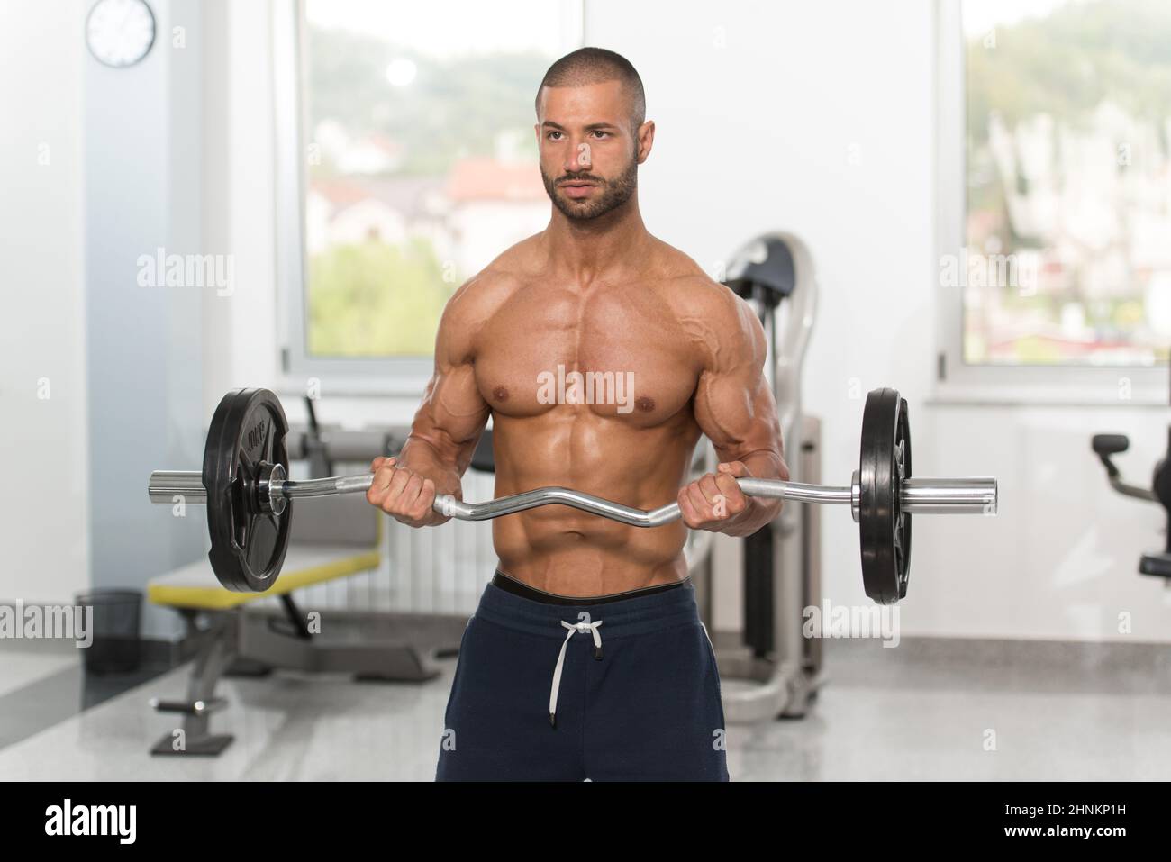 Biceps Exercise With Barbell Stock Photo - Alamy