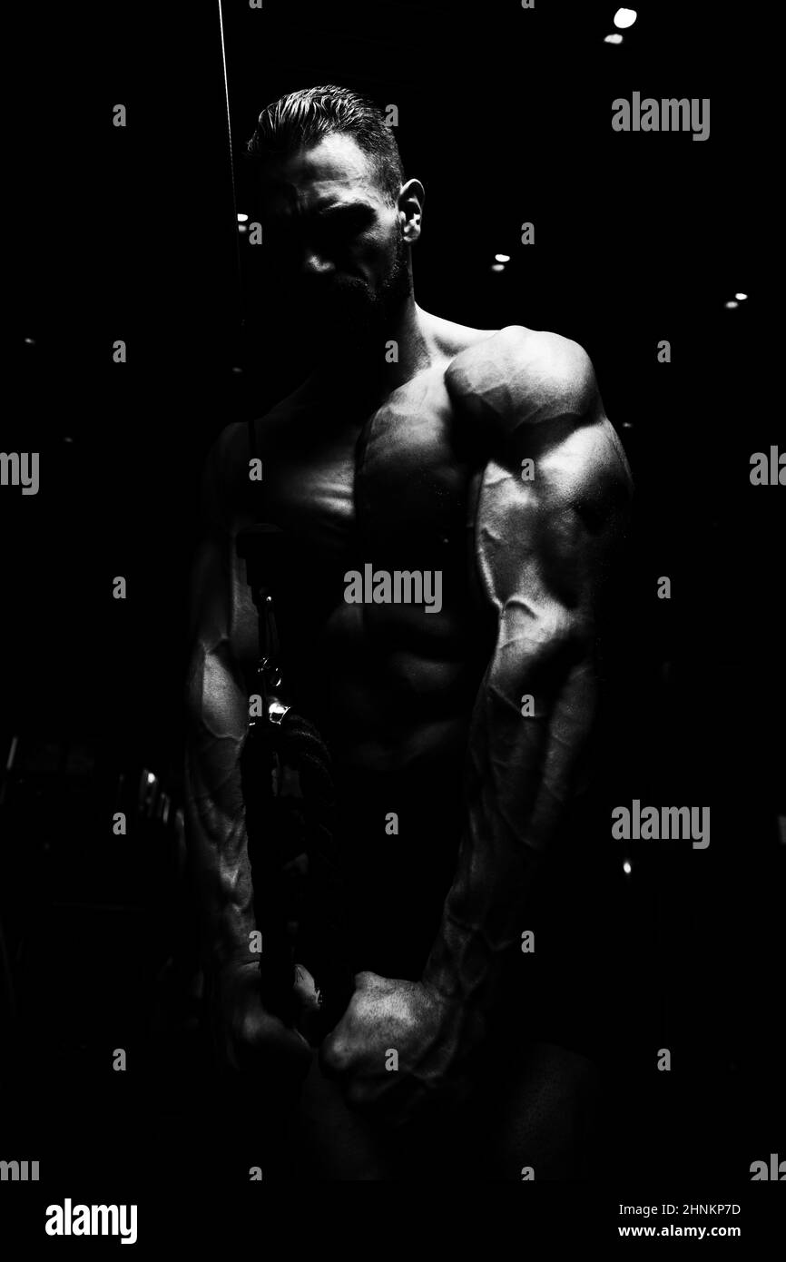 Bodybuilder Doing Heavy Exercise For Triceps With Cable Stock Photo - Alamy