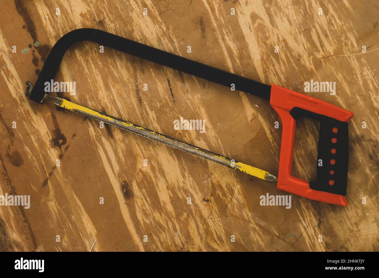 Hand saw on a wooden background. working area with hand instrument ...