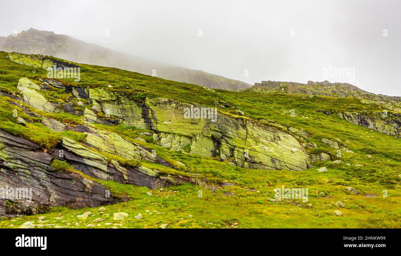 Fog, clouds, rocks and cliffs on mountain in norwegian landscape ...