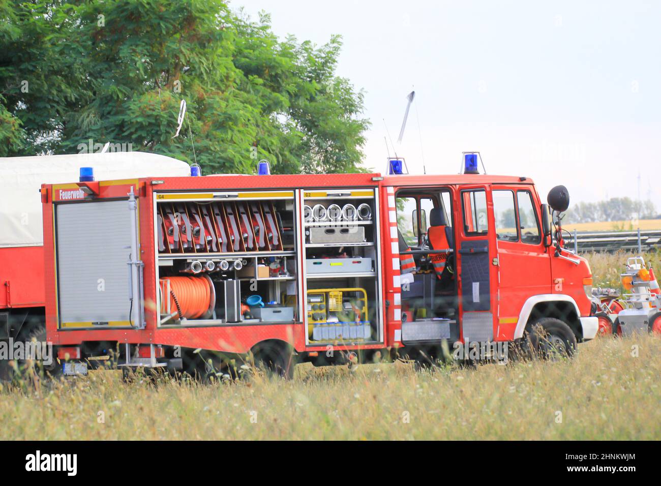 A fire engine with the side open. Lots of hoses and other equipment ...