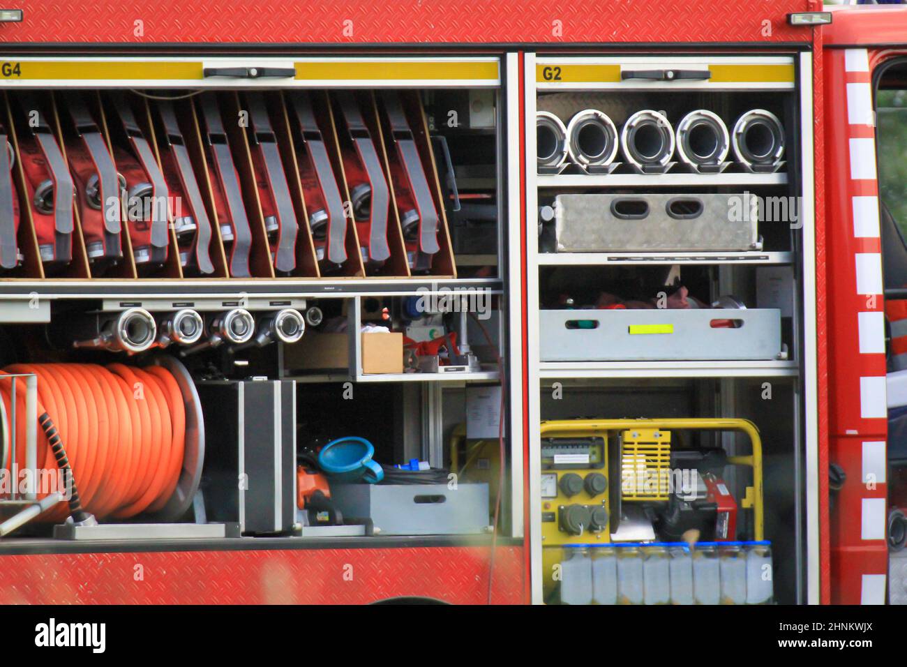 A fire engine with the side open. Lots of hoses and other equipment ...