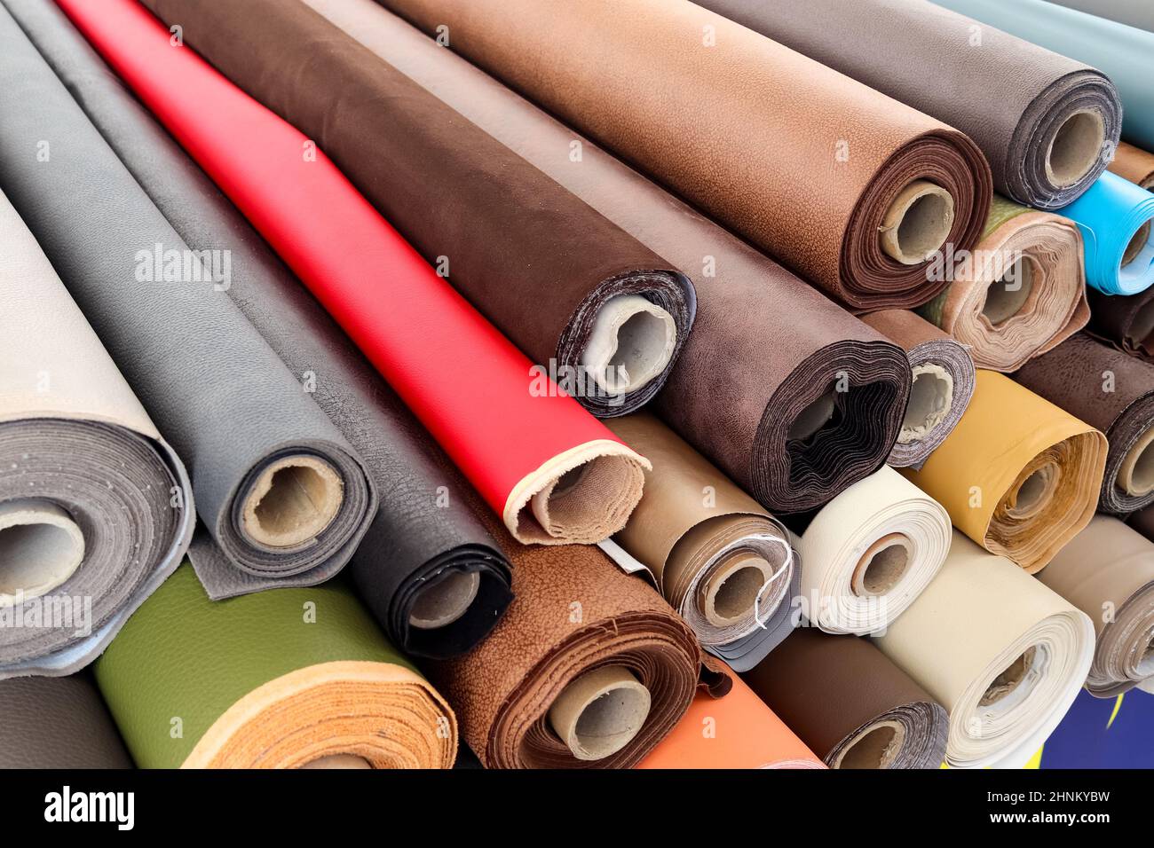Close up view on rolled samples of cloth and fabrics in different ...