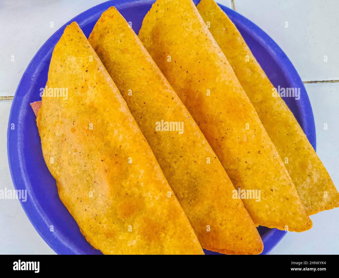 Mexican empanada on blue plate white background from Playa del Carmen ...