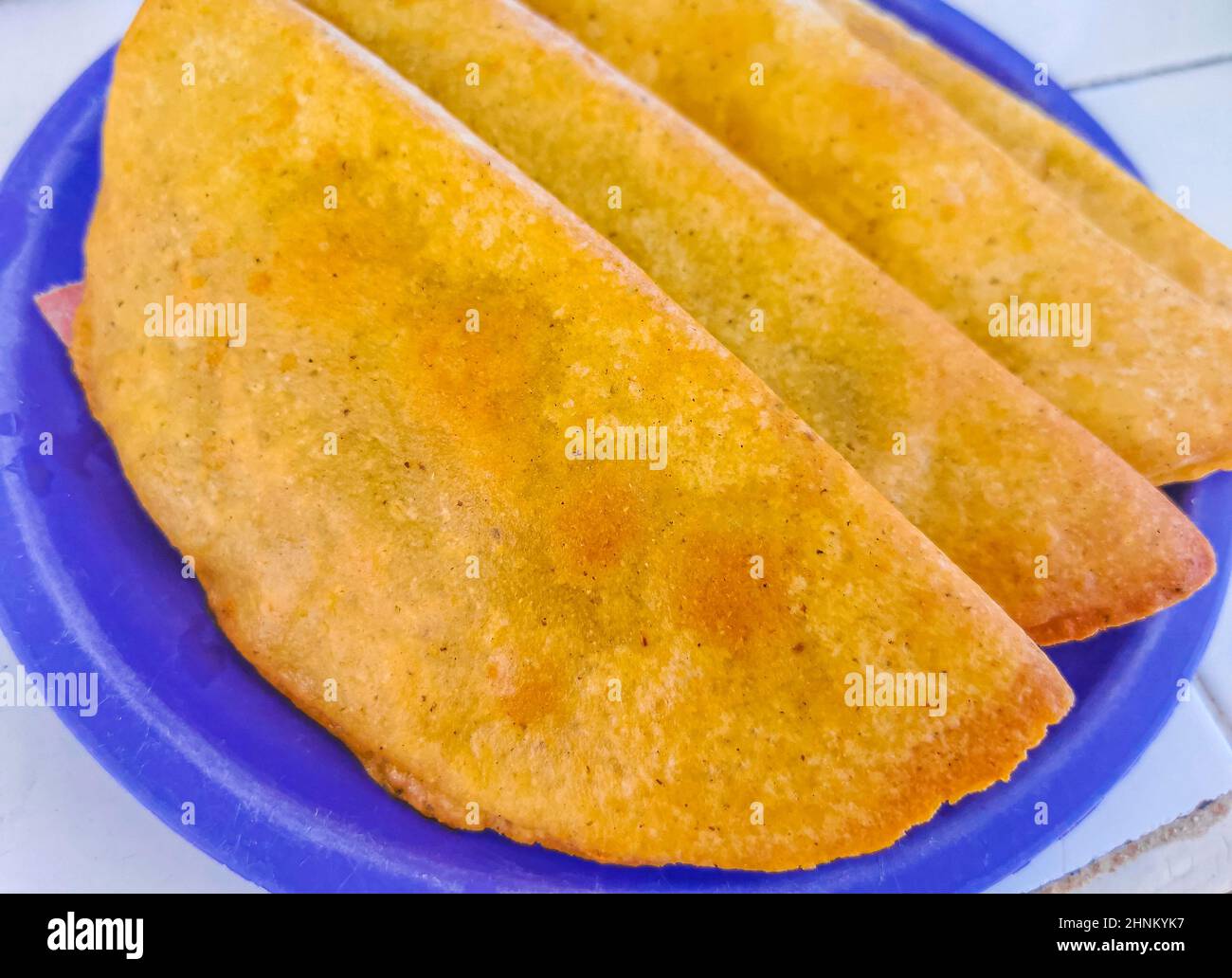 Mexican empanada on blue plate white background from Playa del Carmen ...