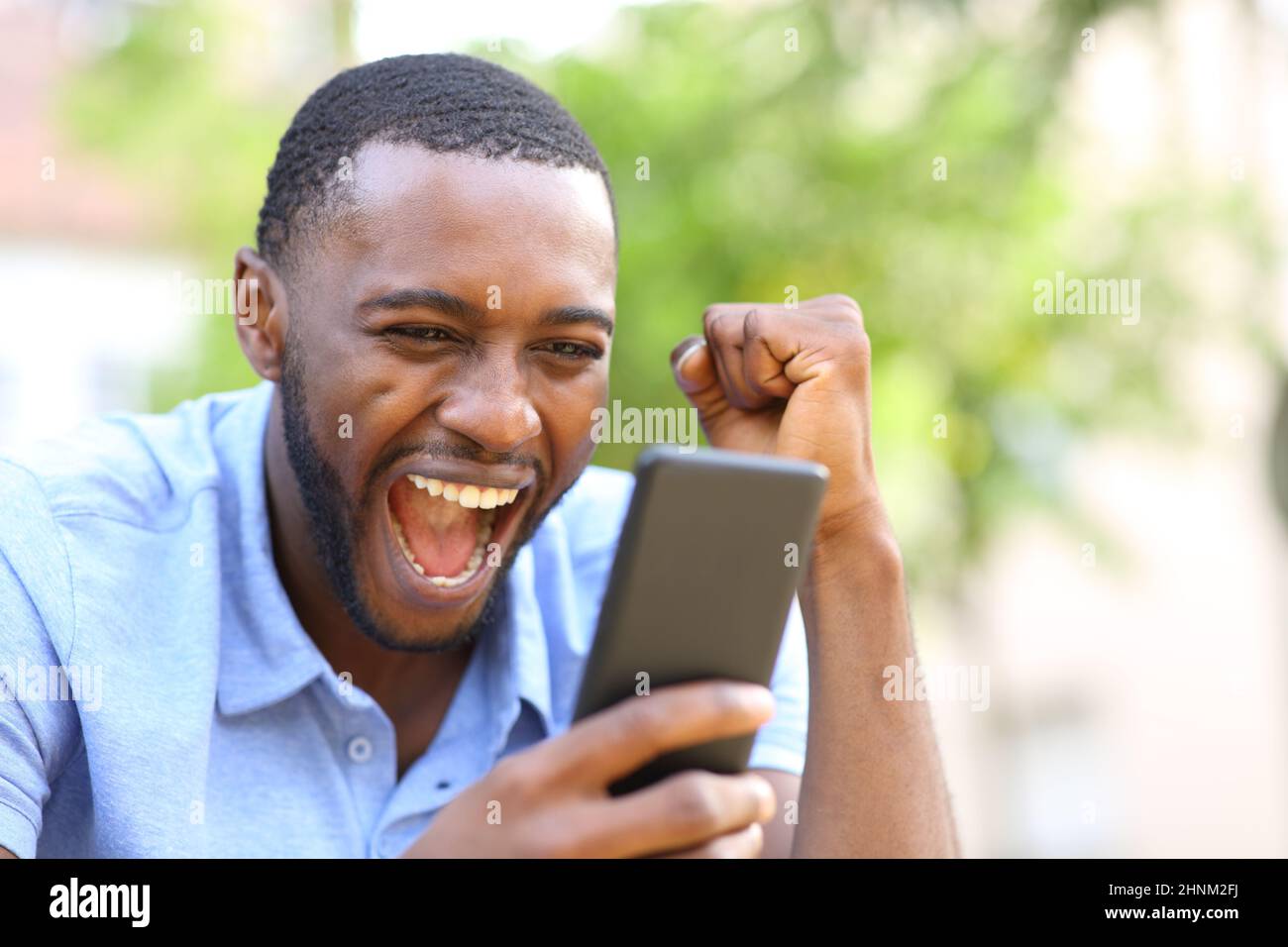 Excited man checking smart phone hi-res stock photography and images ...