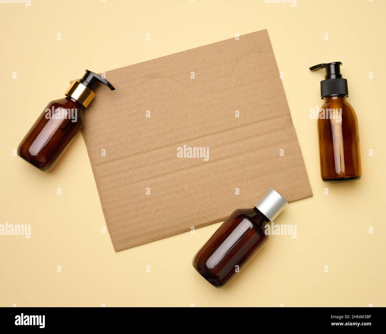 blank brown sheet of corrugated paper and brown glass bottles with ...