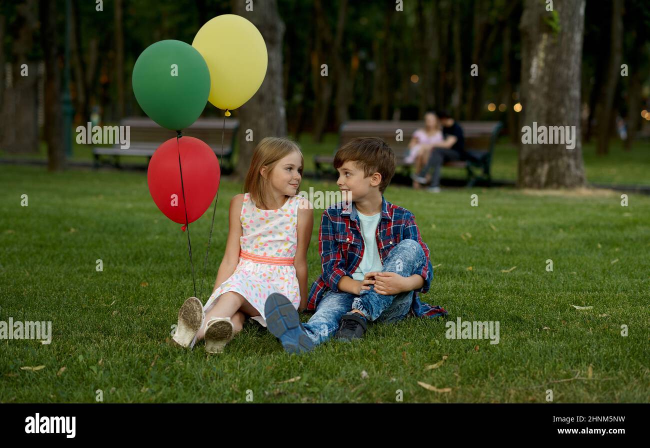 Children's romantic date in summer park, friendship, first love. Boy ...