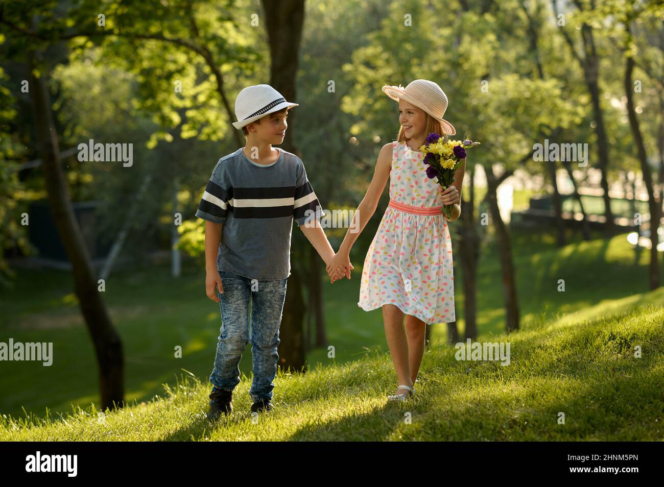 Children's romantic date in summer park, friendship, first love. Boy ...