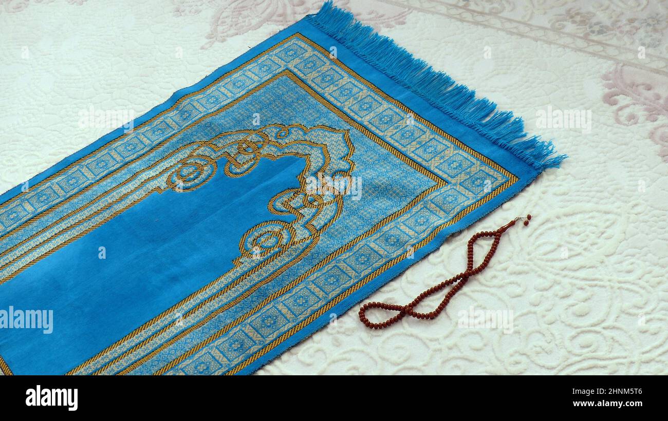 prayer rug and rosary, blue prayer carpet used for praying in Islam ...