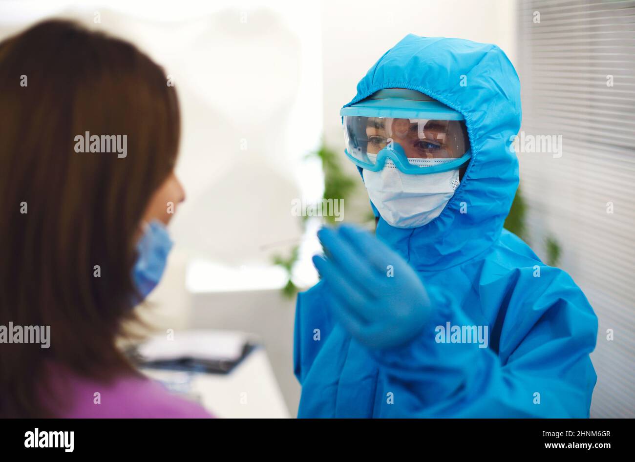 Medical worker in personal protective equipment PPE doing PCR test to ...