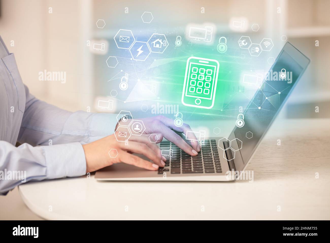 Hands working on laptop with digital icons Stock Photo - Alamy
