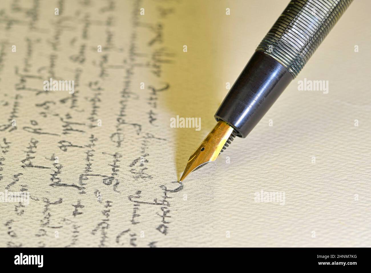 Fountain pen on paper with ink text on vintage handwriting. Close-up ...