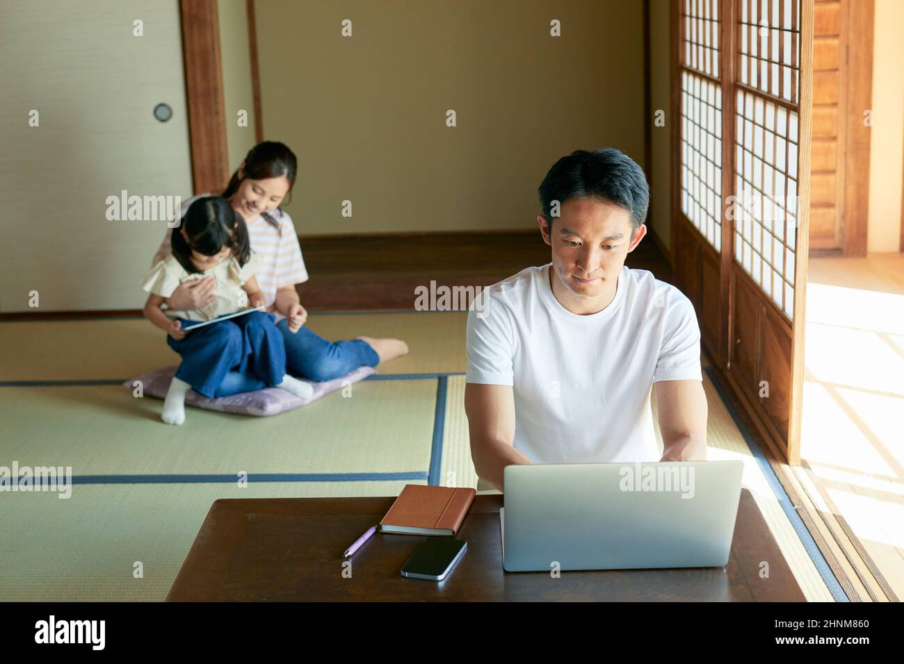 Japanese Man Working From Home And His Family Stock Photo - Alamy