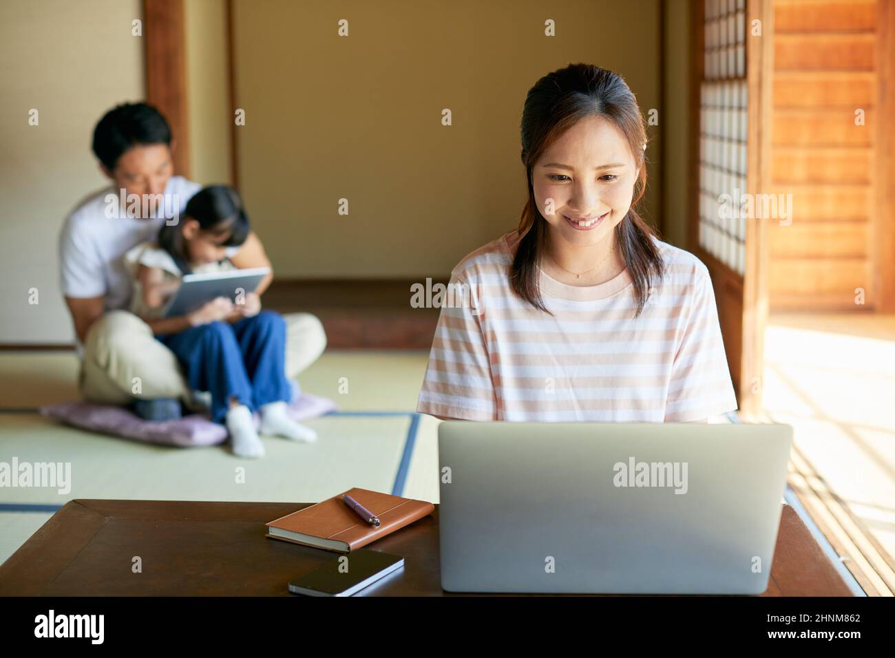 Japanese Woman Working At Home And Her Family Stock Photo - Alamy