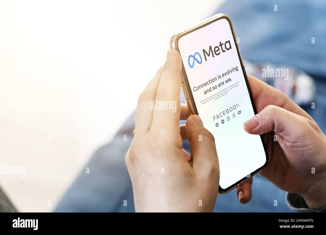 Woman holding a phone with the Meta mobile app on the screen Stock ...