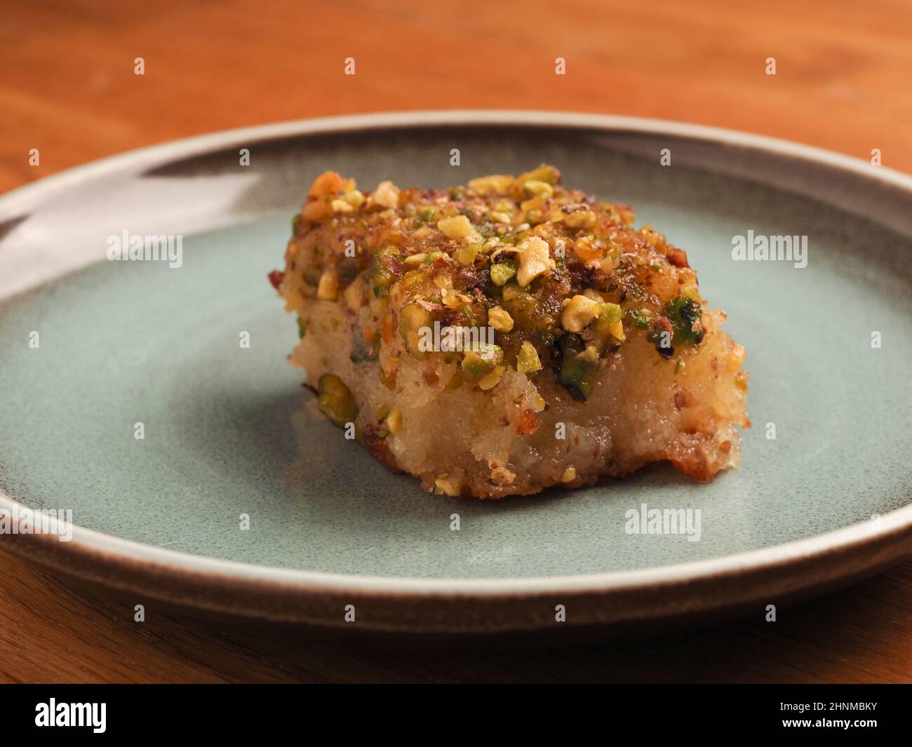 Syrian semolina cake with sugar syrup, tasty Harisse on a blue ceramic ...