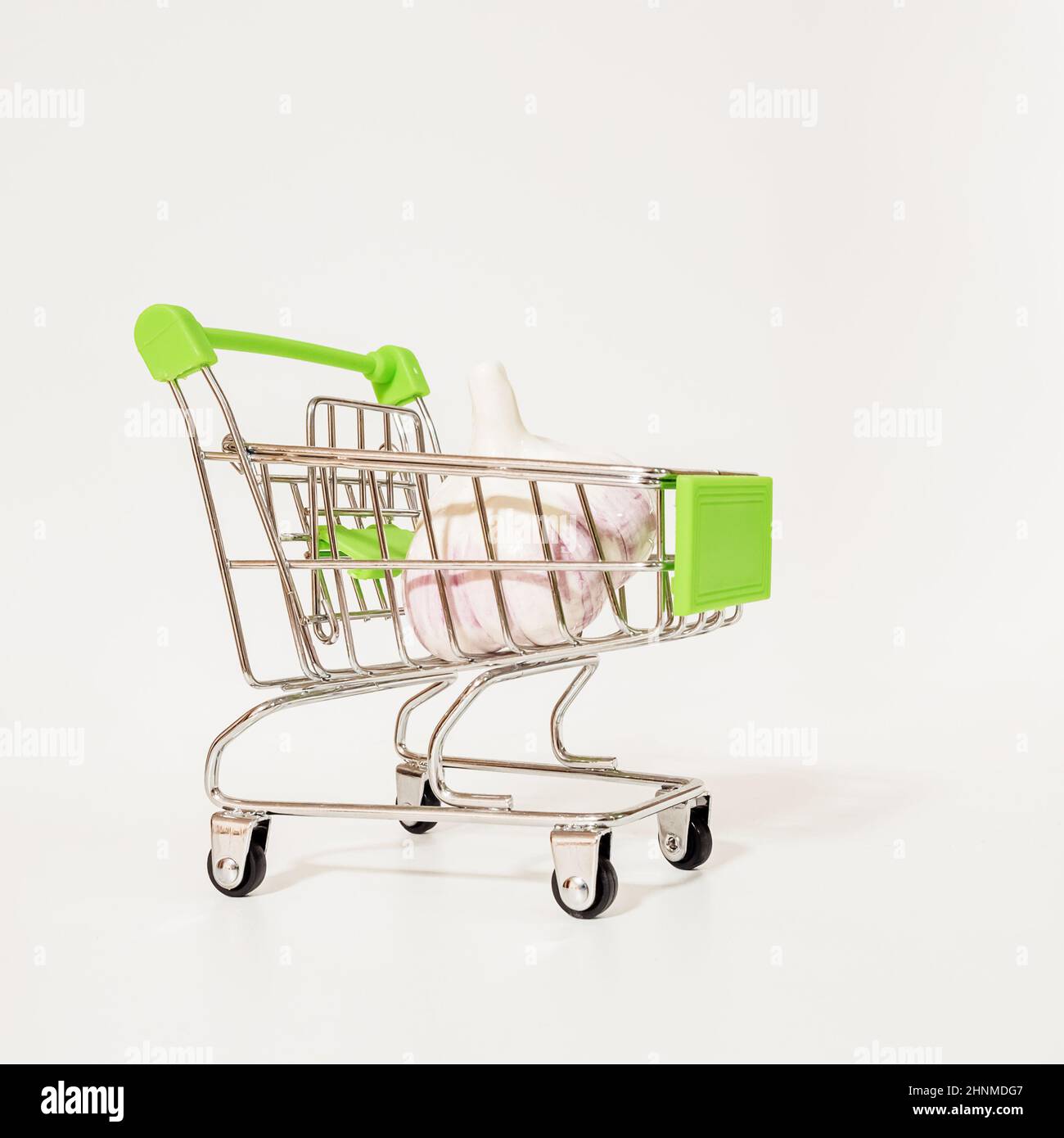 Small toy cart on wheels with garlic on isolated background Stock Photo ...
