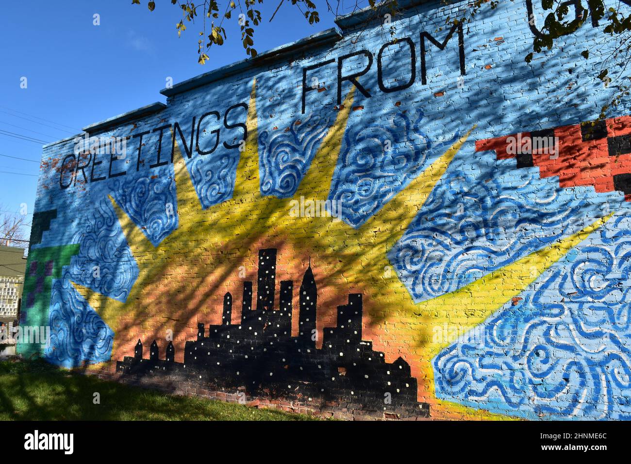 Colourful mural featuring sun and skyline at the corner of Gratiot Ave ...