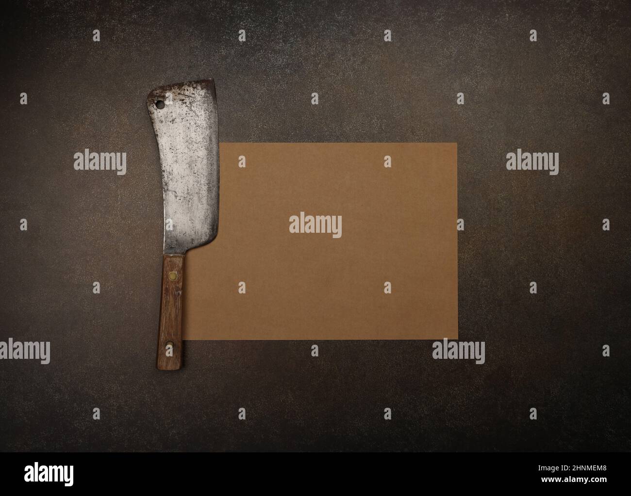 Close up one vintage butcher meat cleaver and brown paper on cutting ...